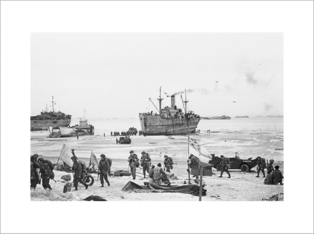 Troops come ashore on one of the Normandy invasion beaches, past the W ...