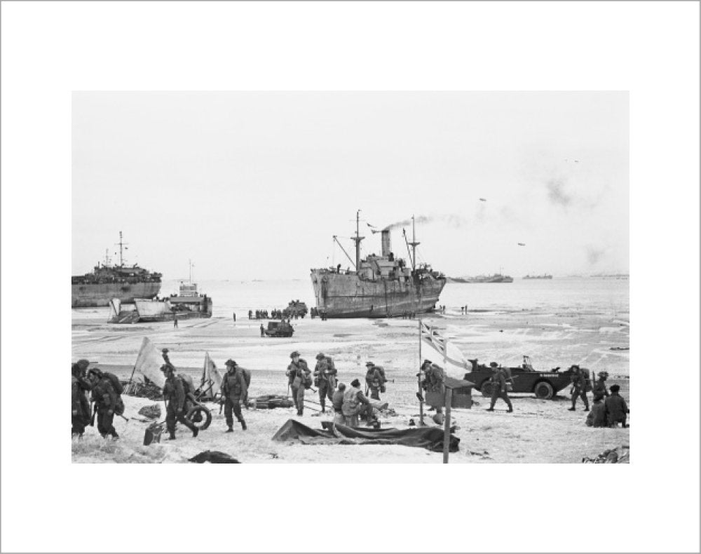 Troops come ashore on one of the Normandy invasion beaches, past the W ...