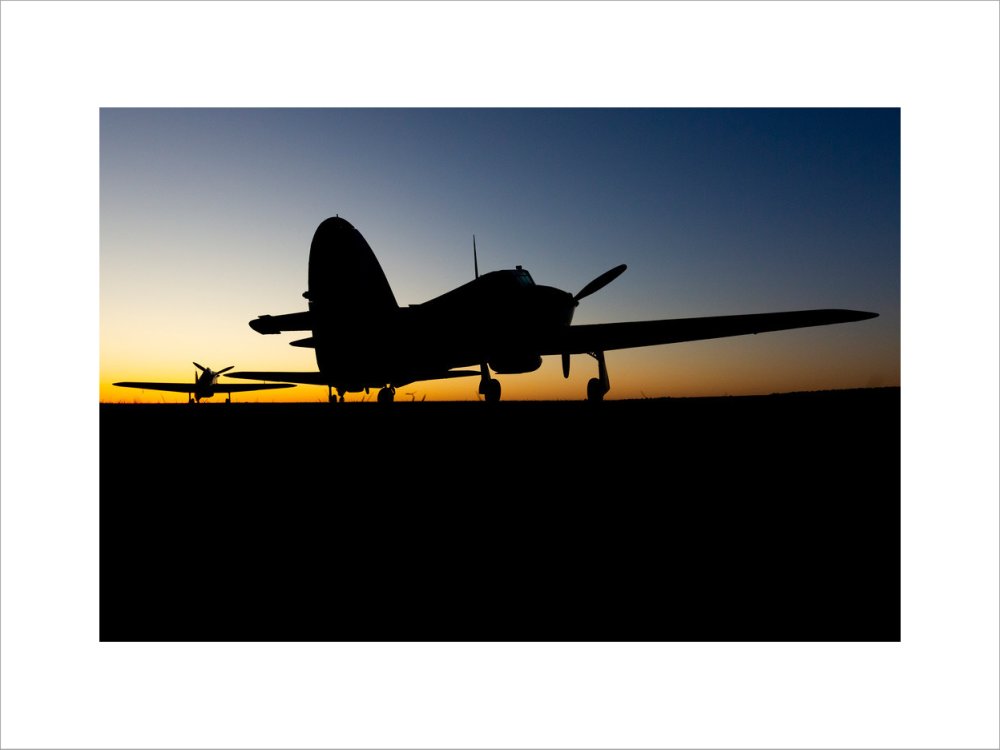 Two Hawker Hurricanes at the Duxford Airfield during sunrise – IWM Prints